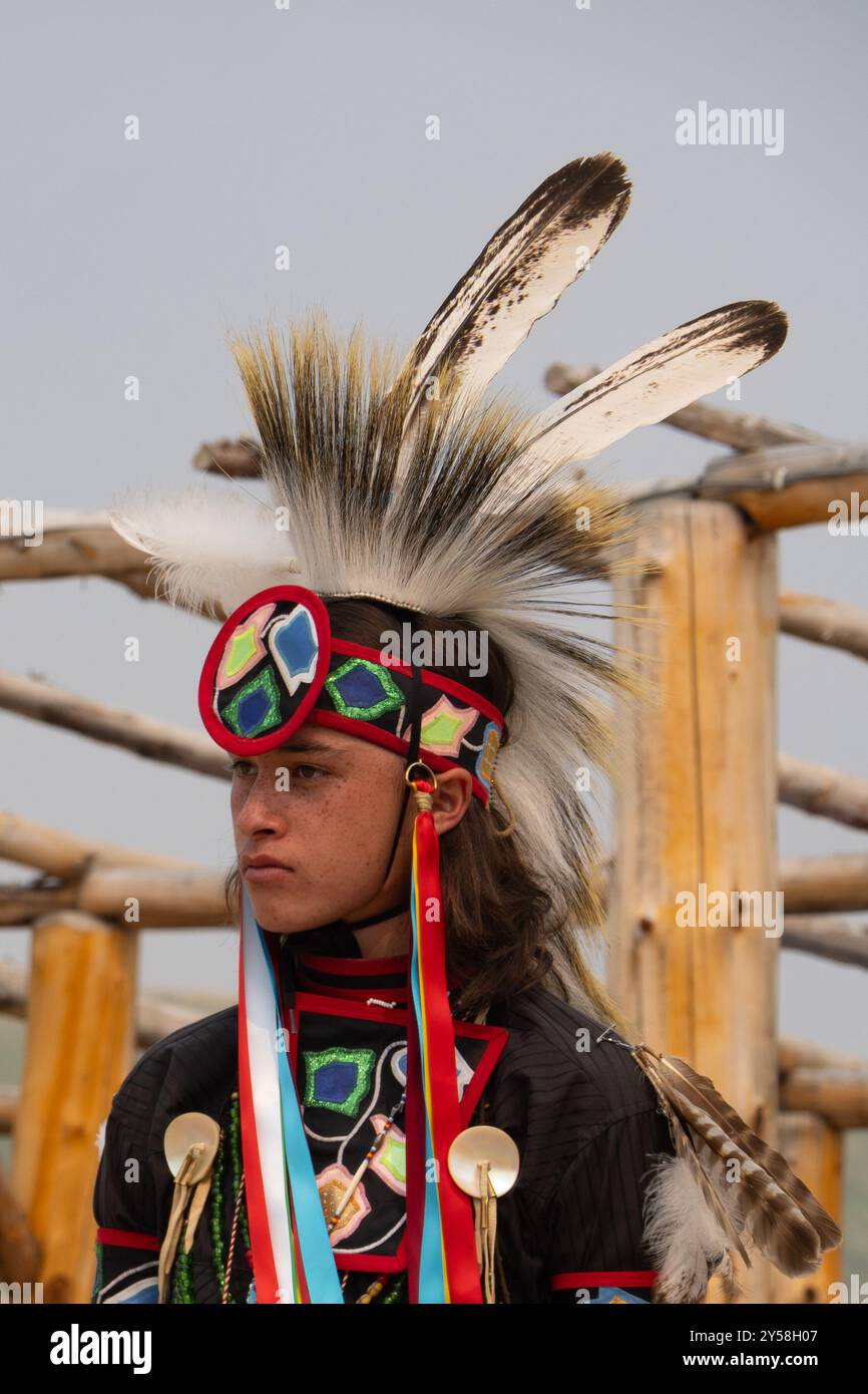 Close-Up of a Young Native American Man in a feathered headdress and ...