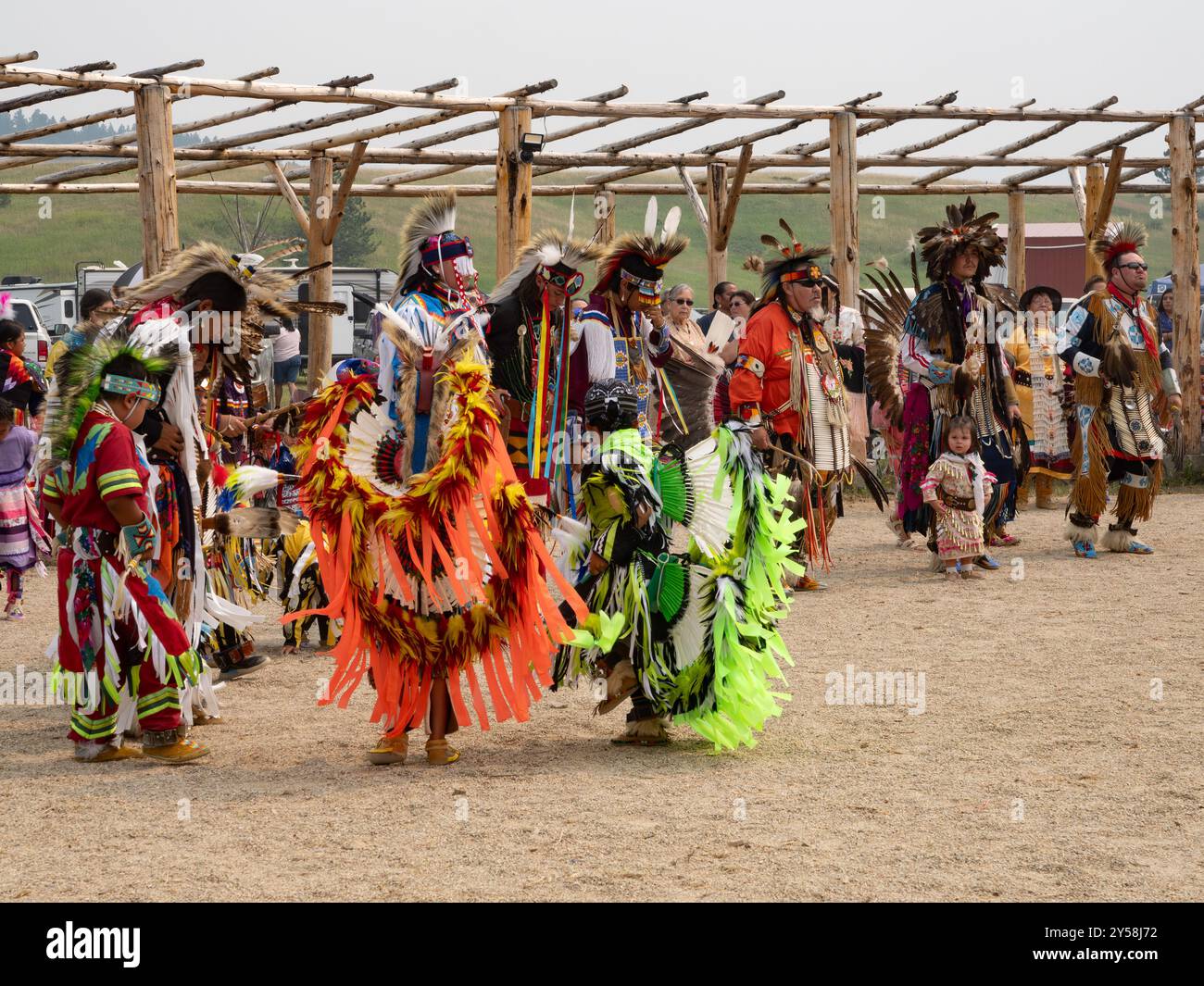 Group of Native American men, women, and children dressed in full ...