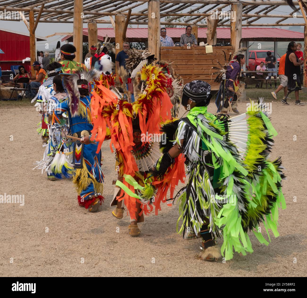 Native American boys dressed in fancy dancer costumes dancing at a ...