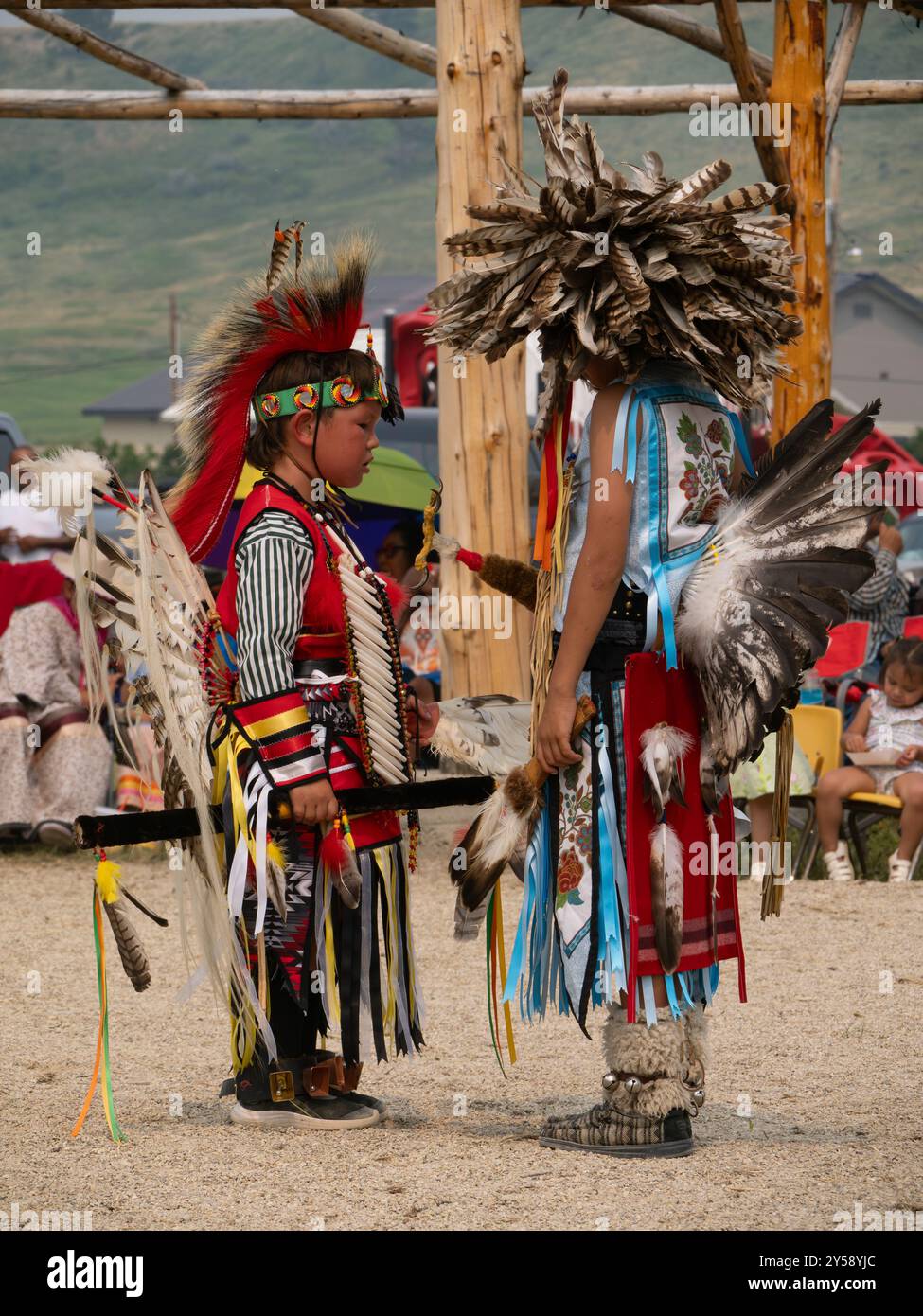 Two Native American boys wearing traditional costumes at a powwow in ...
