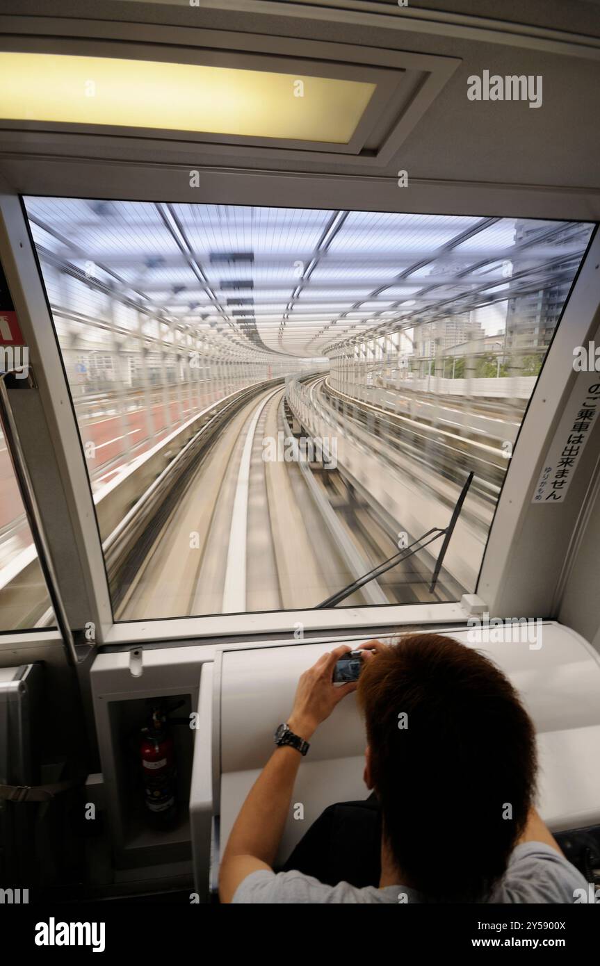 Automated guideway transit train (Yurikamome Line) on its track along ...