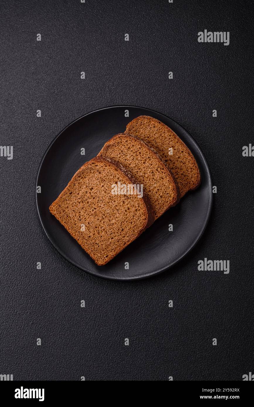 Fresh crispy brown bread sliced from whole grain flour with salt and ...