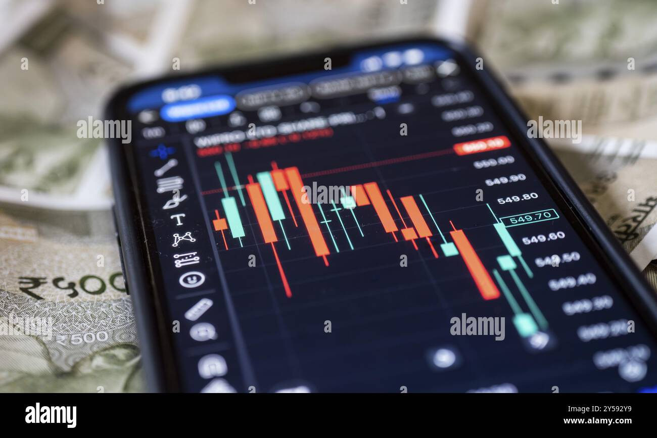 Stock market graph or chart display on a mobile phone against Indian ...