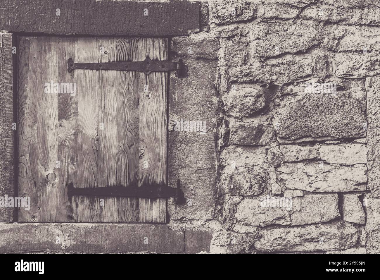 Architectural frame with a weathered wooden trap door and the stone ...
