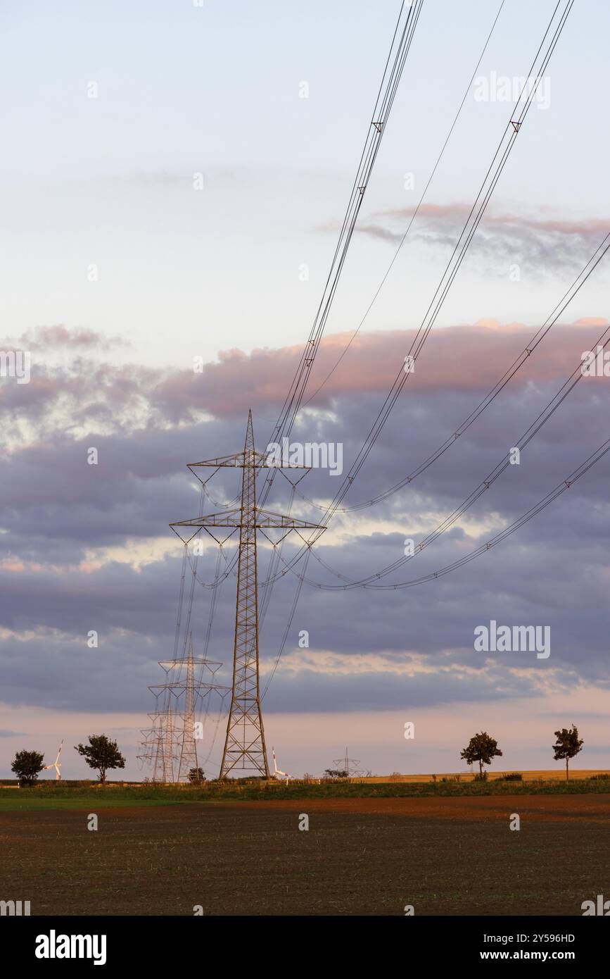 Power line Lattice masts Power transmission at sunset Stock Photo - Alamy