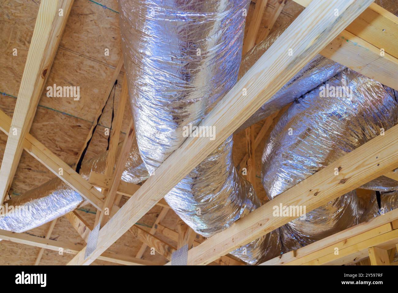 Installation of silver insulation ventilation HVAC pipes from ceiling ...