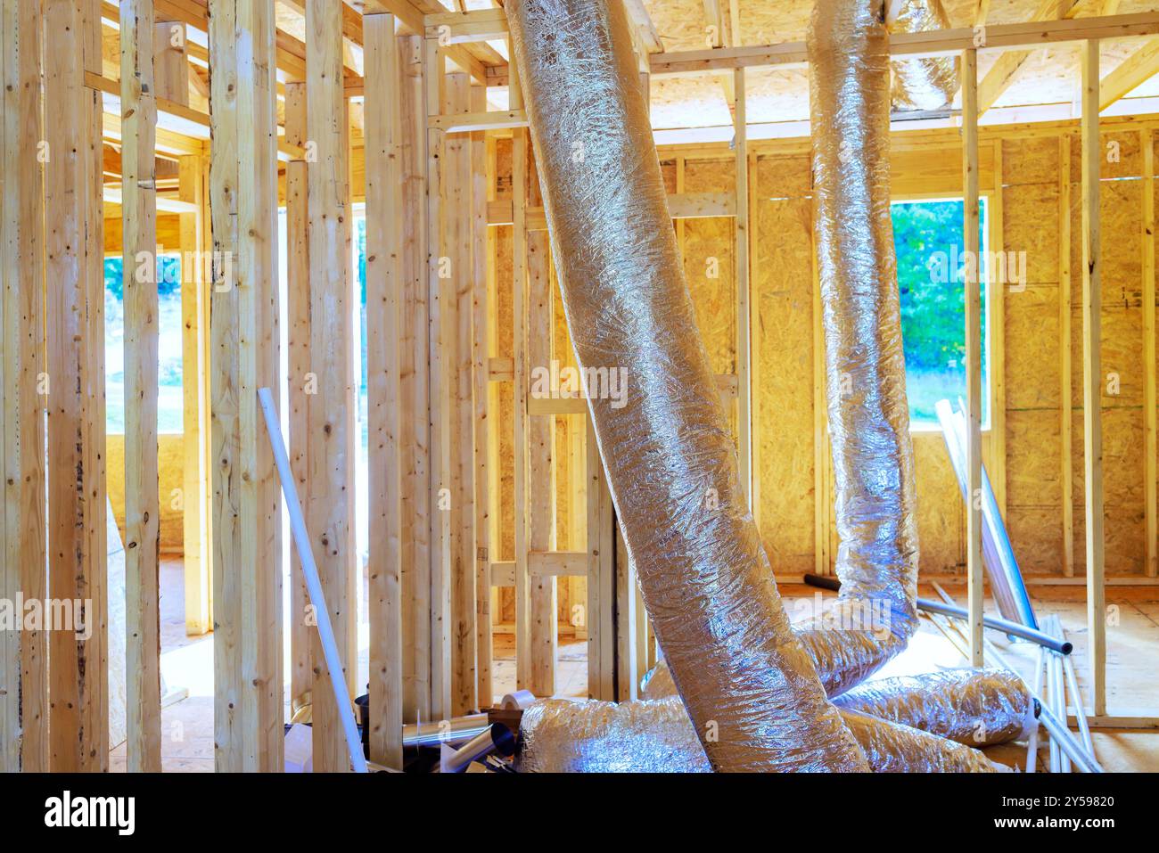 Installing silver insulation ventilation HVAC pipes on ceiling to roof ...