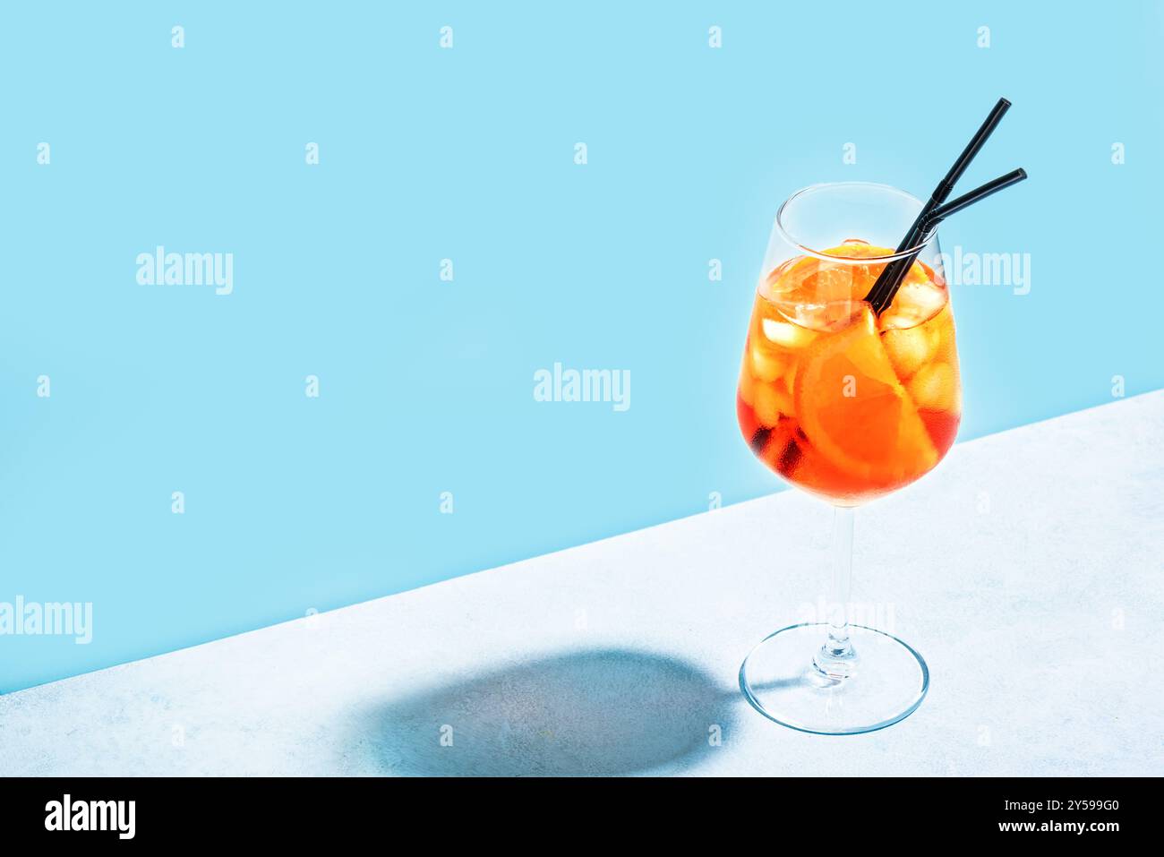 Aperol Spritz Cocktail in glass with orange slices on light blue ...