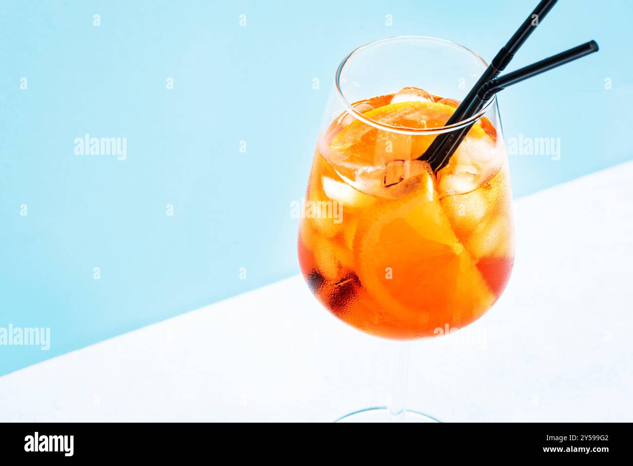 Aperol Spritz Cocktail in glass with orange slices on light blue ...