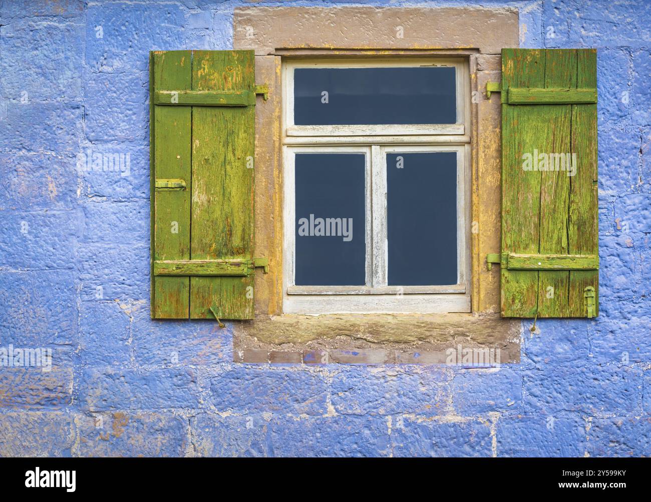 Architectural details over a window with wooden shutters, from an ...