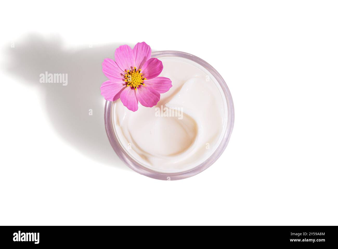 Cosmetic cream jar with delicate pink flower isolated on white ...