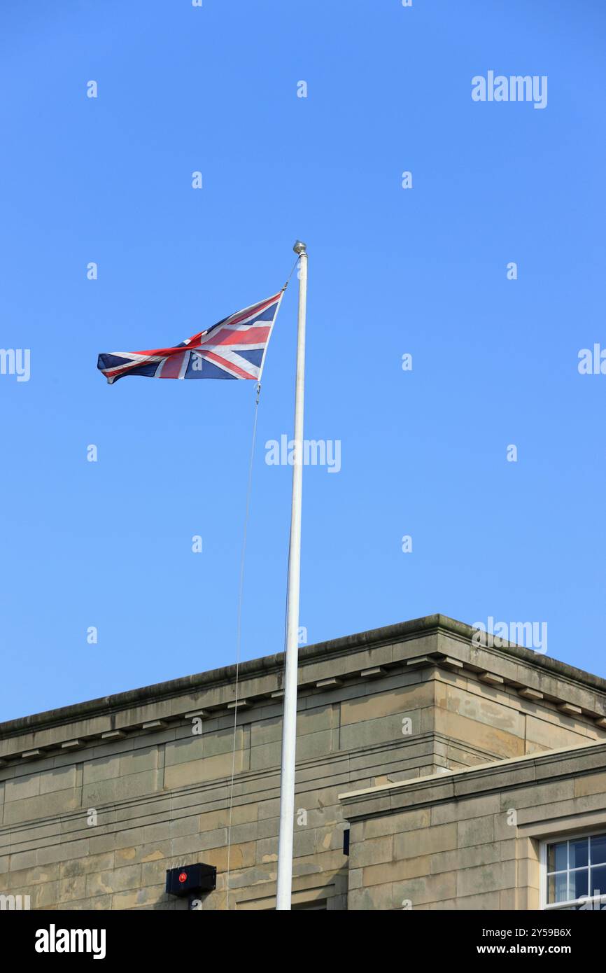 Union flag flying on flagpole next to bury town hall in bright sunshine ...