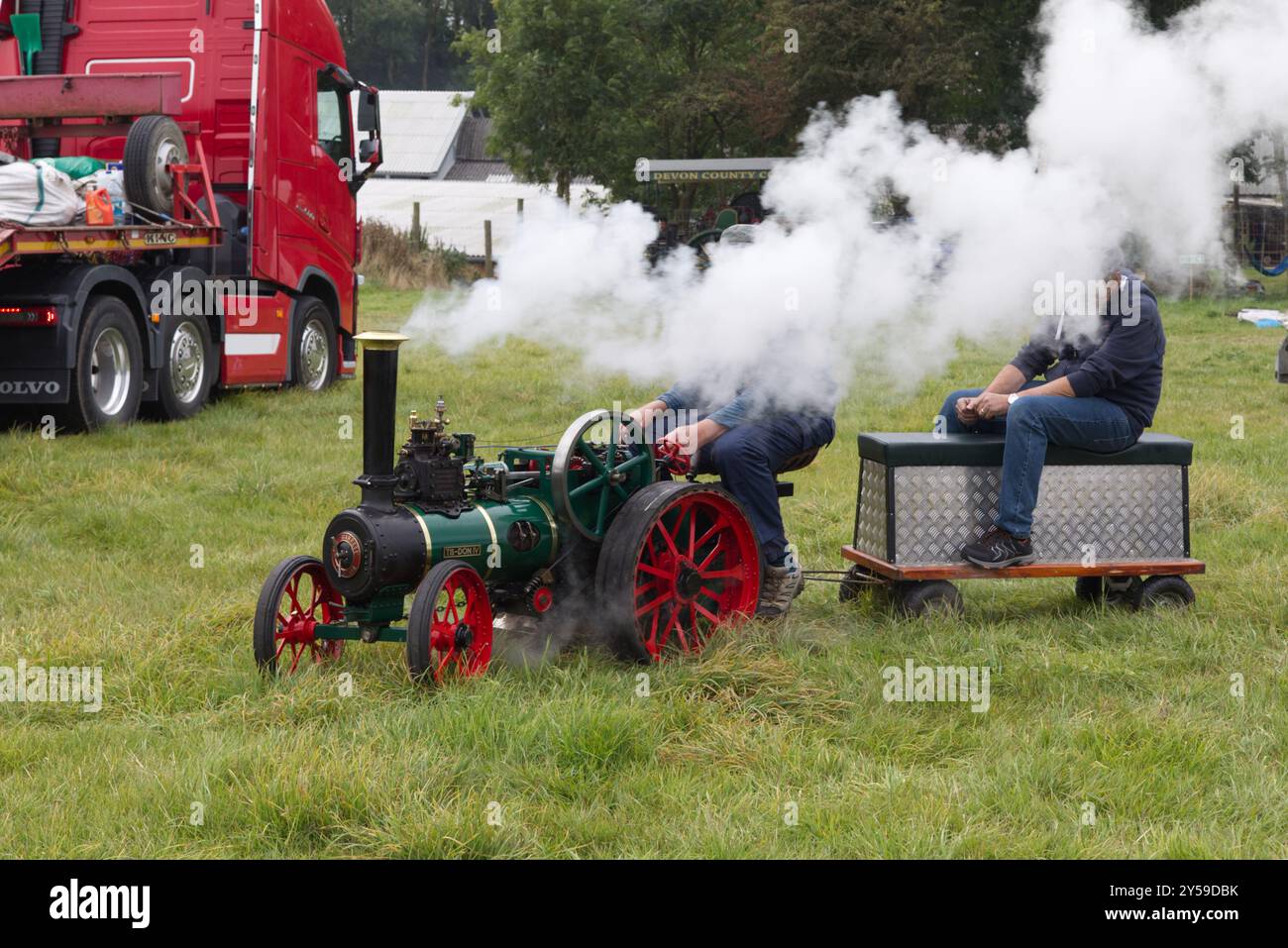 Mini steam engine pulling a trailer Stock Photo - Alamy