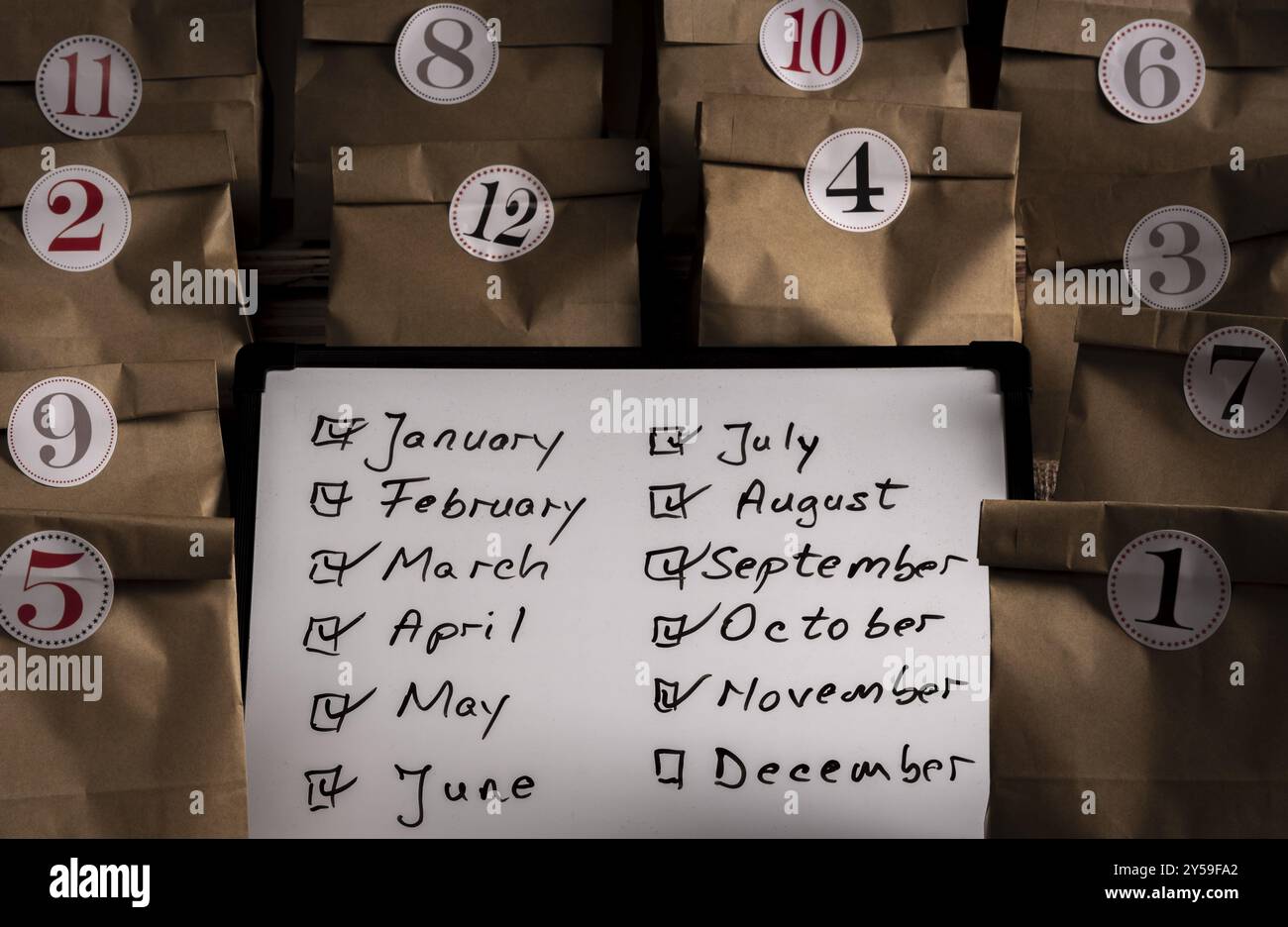 Writing board with the list of the months of the year and paper bags ...