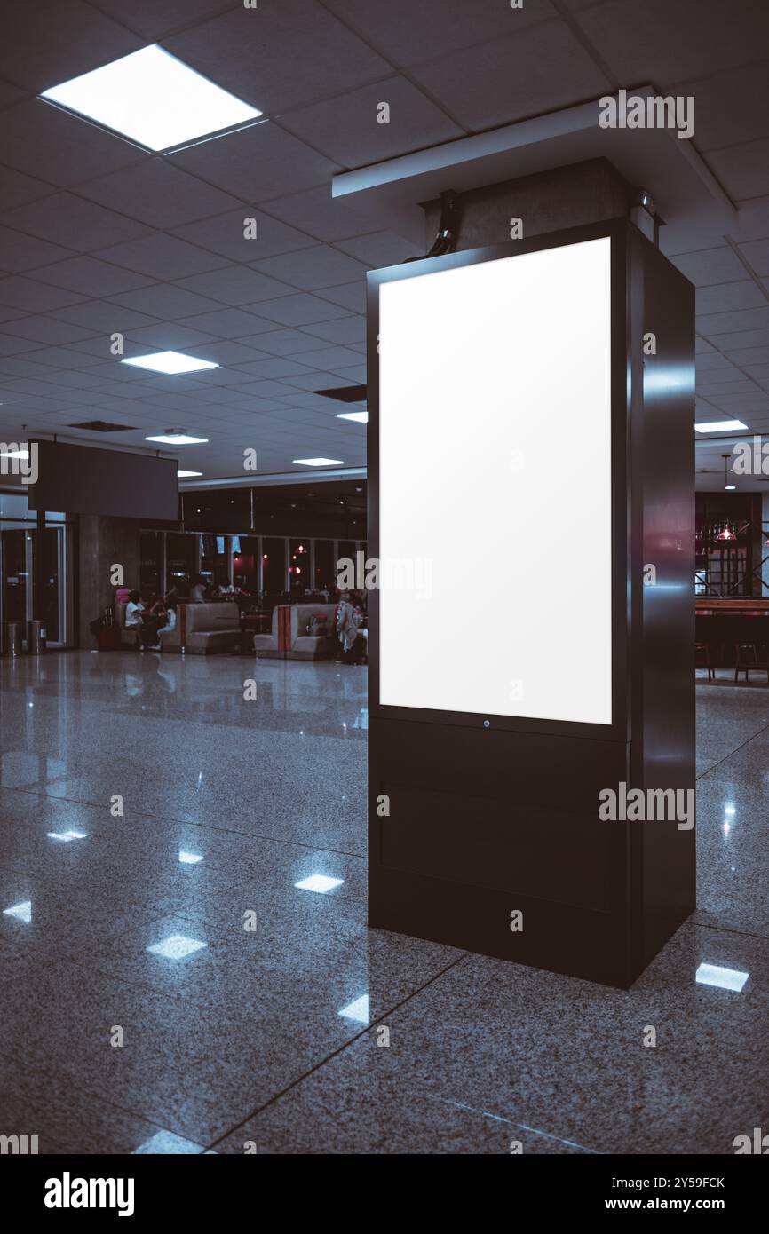 Blank digital advertising display in a spacious airport terminal. The ...