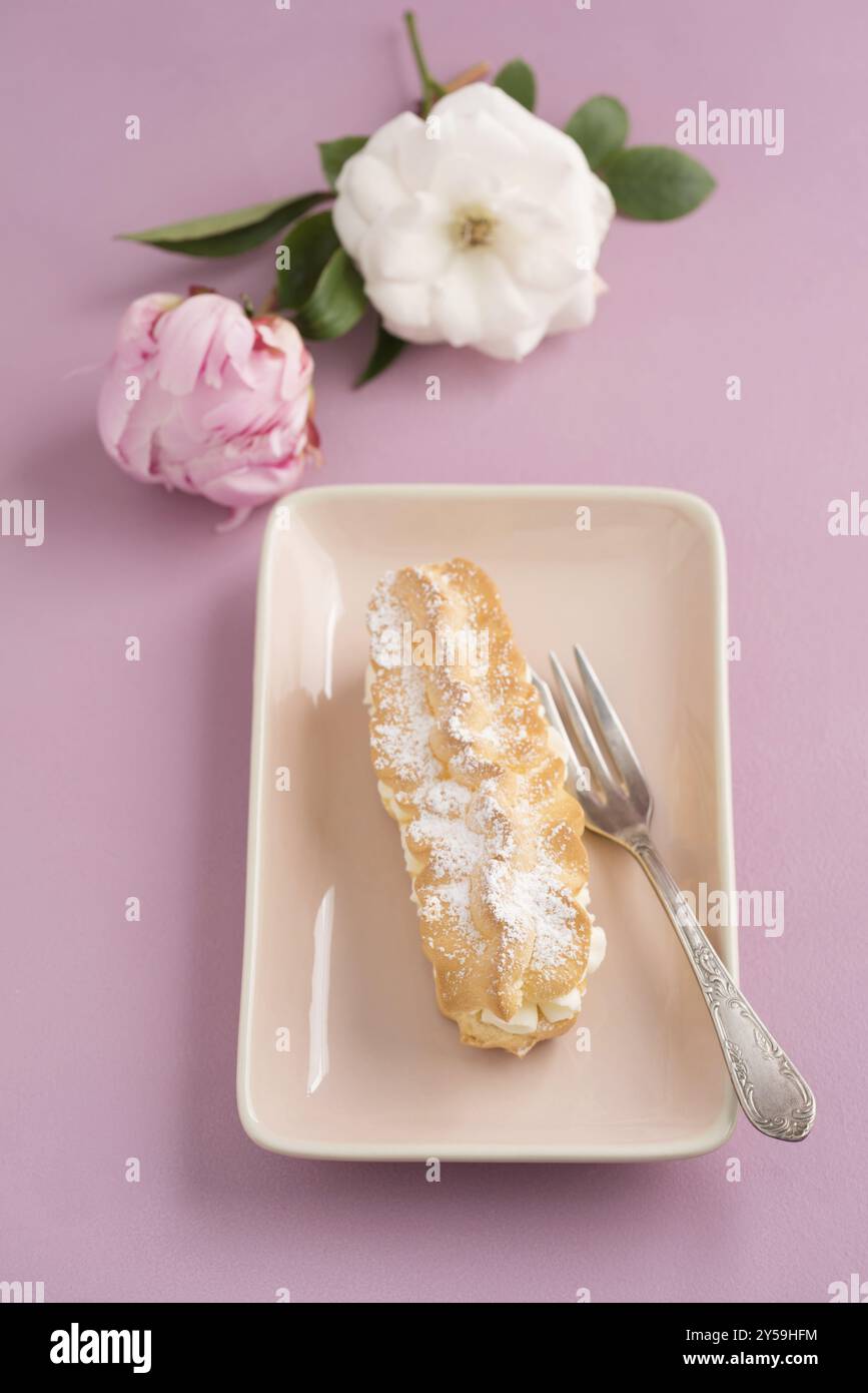Eclairs with buttercream filling and powdered sugar Stock Photo - Alamy