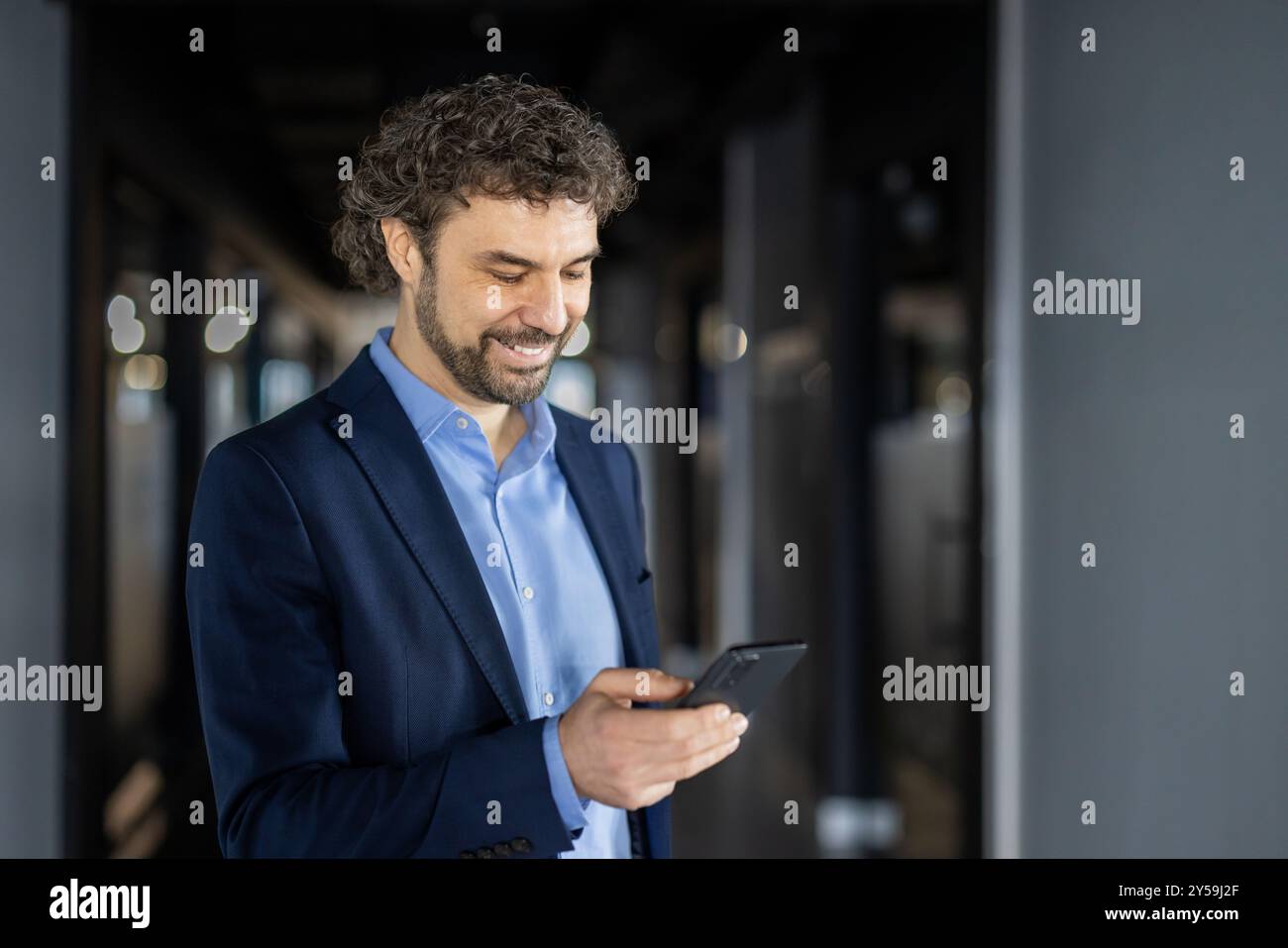 Confident businessman dressed in formal attire uses smartphone in ...