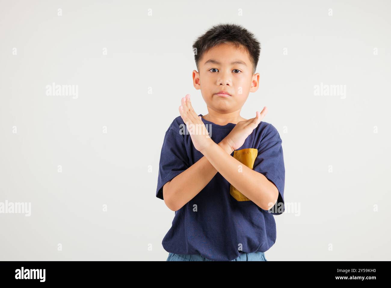Portrait Asian young kid boy unhappy or confident standing holding two ...