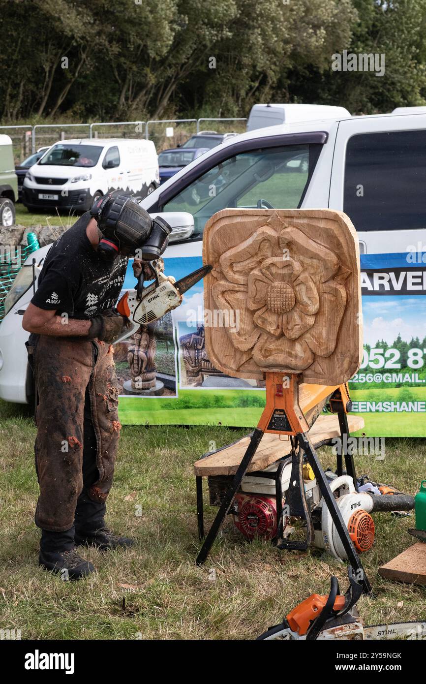 A skilful Craftsman demonstrating woodcarving of a Yorkshire Rose using ...