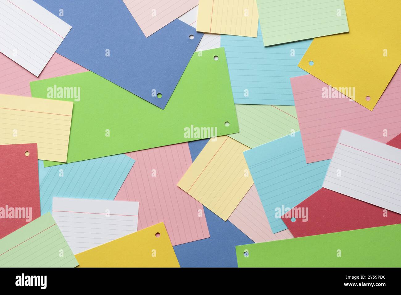 Vibrant background with a multitude of paper notes spread on an office ...