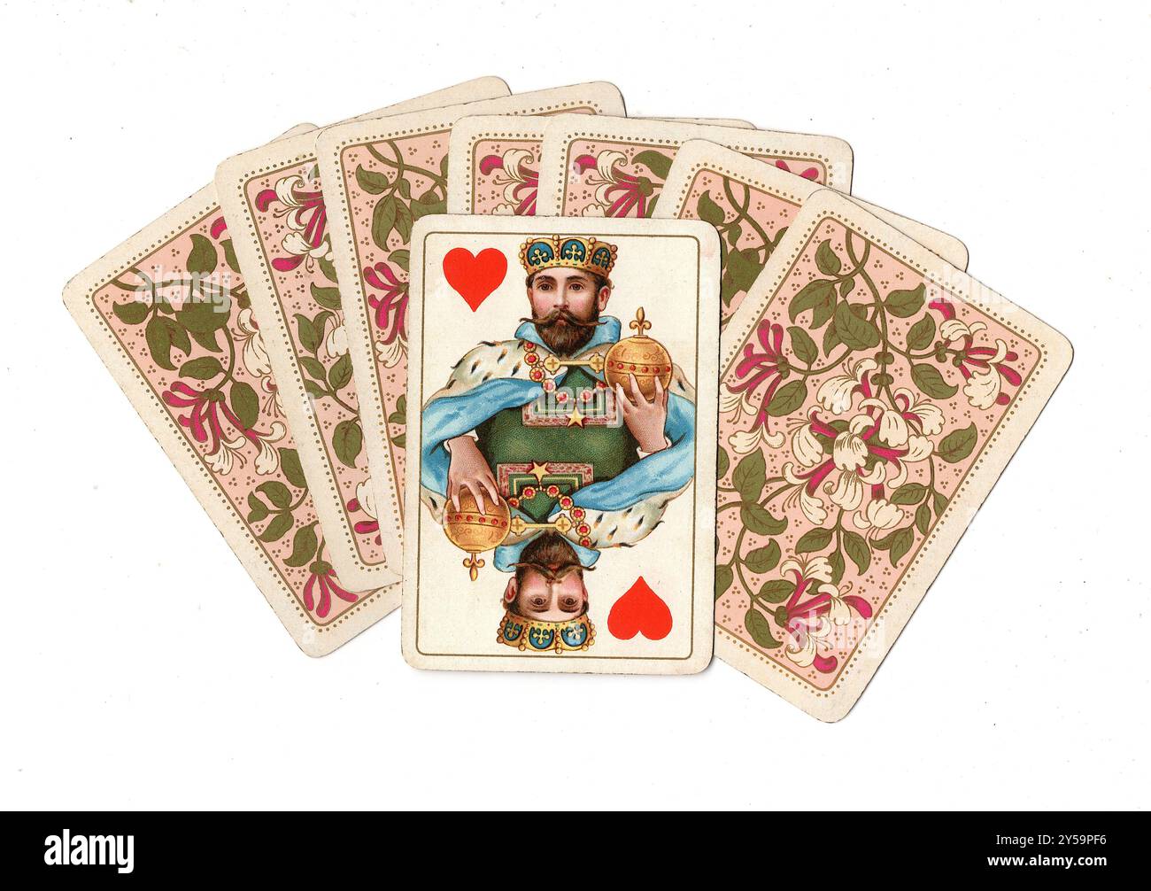 A fan of vintage card backs with one picture card revealed on a white ...