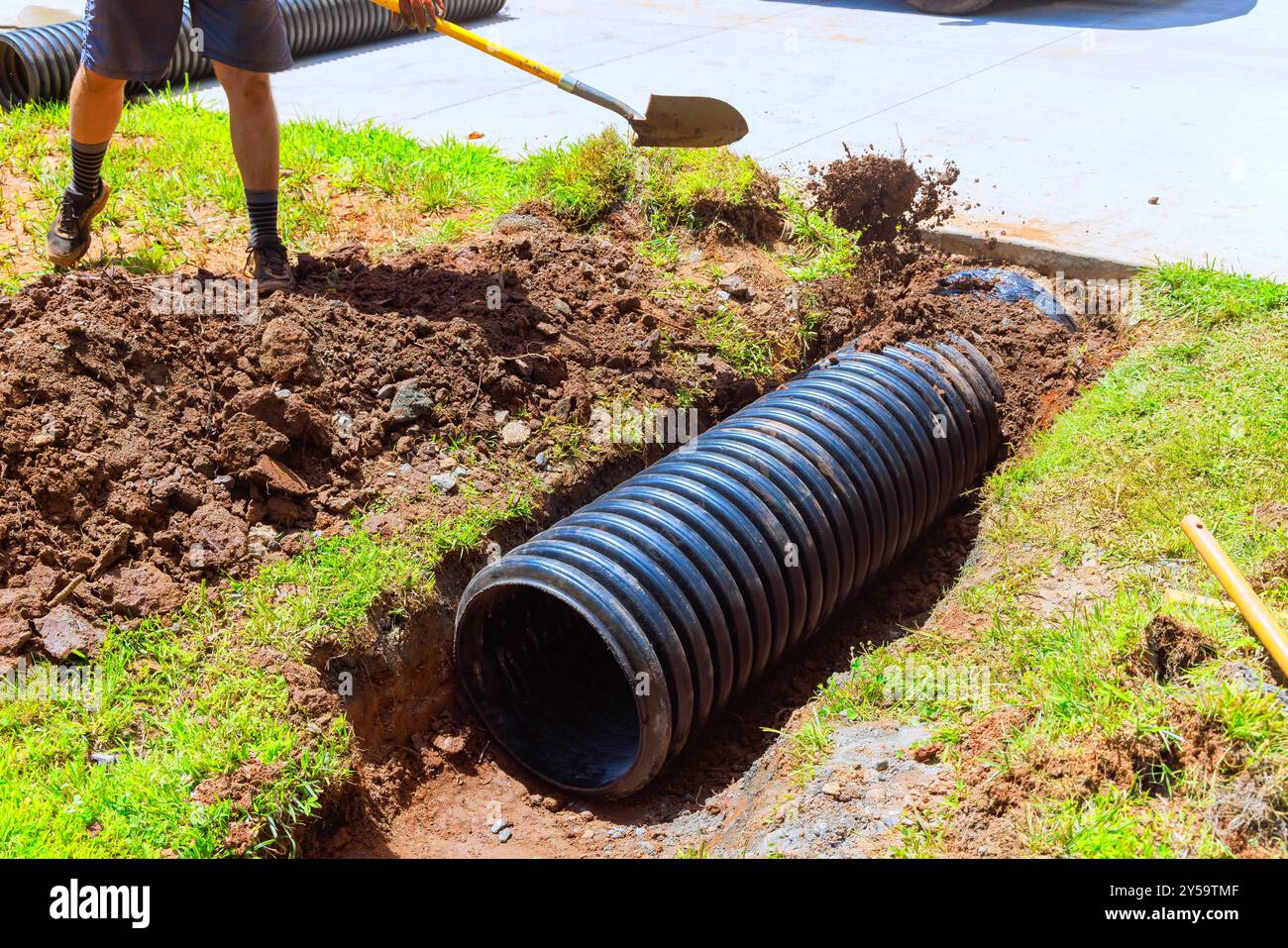 Installation of drainage black pipe in trench during construction Stock ...