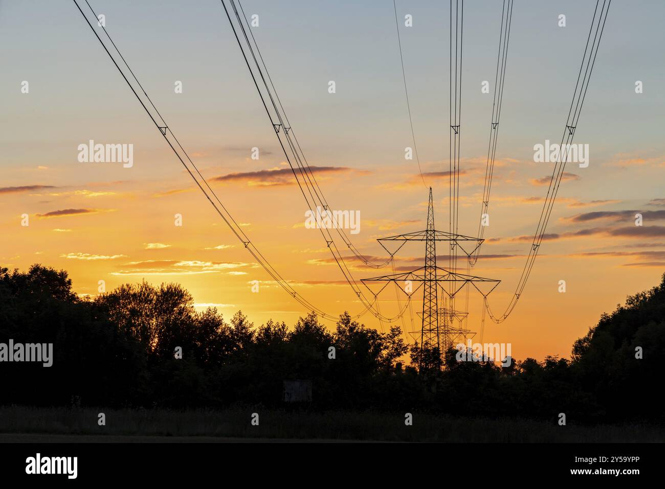 Power line Lattice masts Power transmission at sunset Stock Photo - Alamy