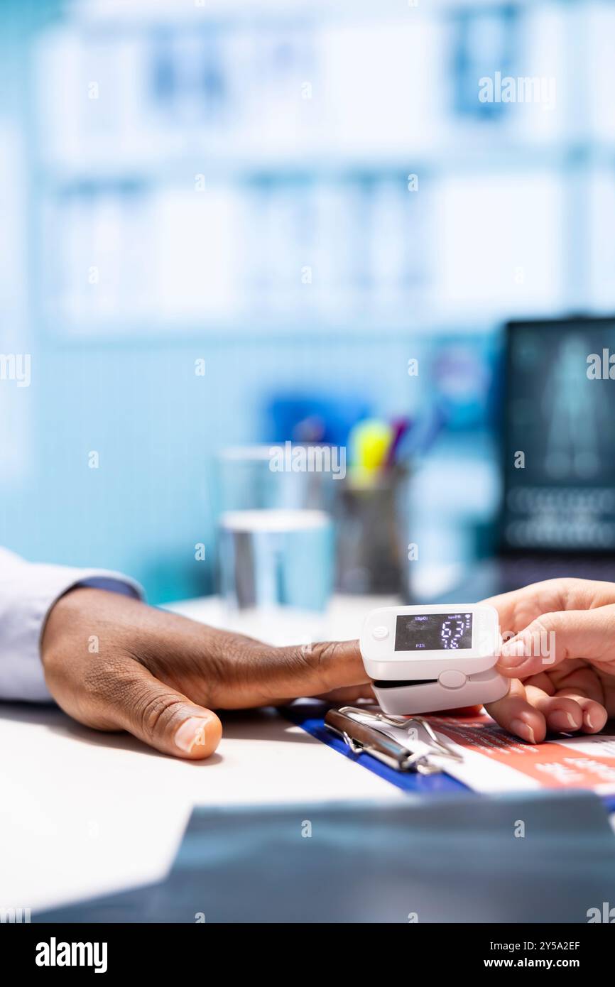 General practitioner taking the oxygen saturation measurement and ...