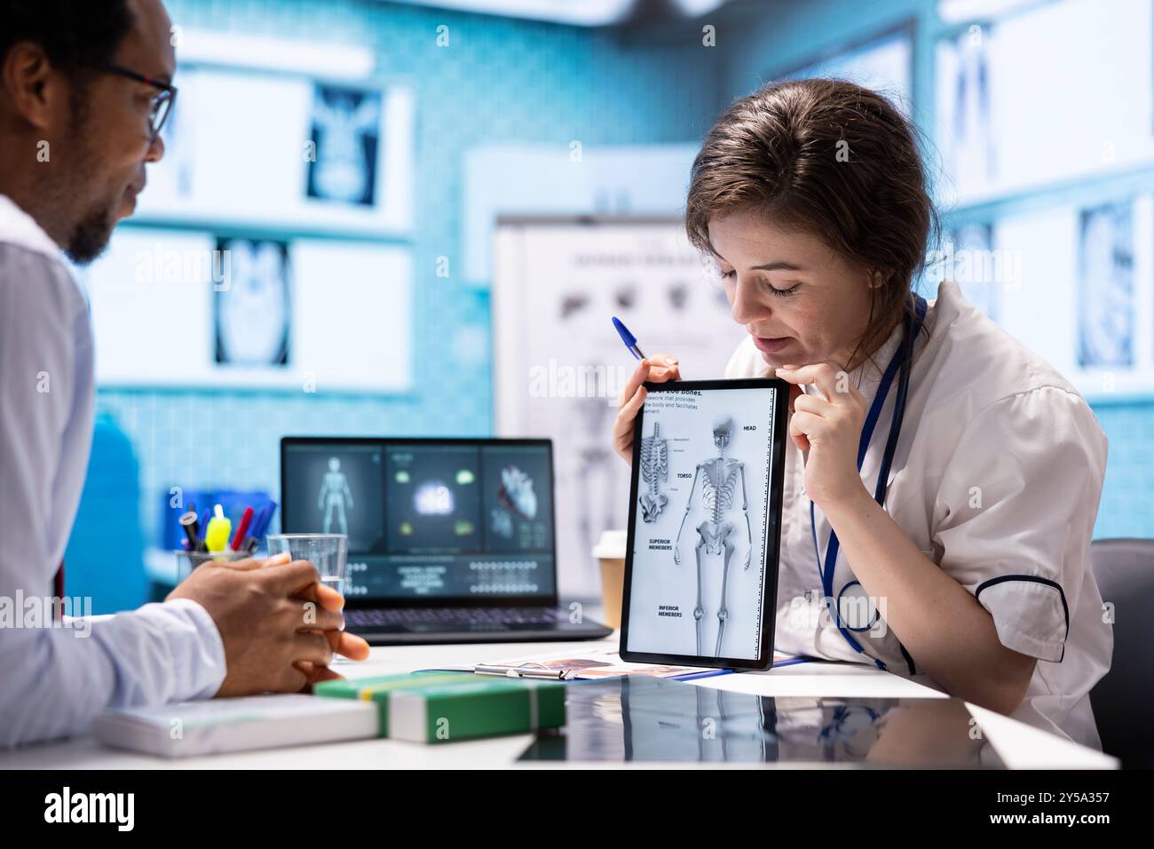 Medical expert explaining the human anatomy to patient in cabinet ...