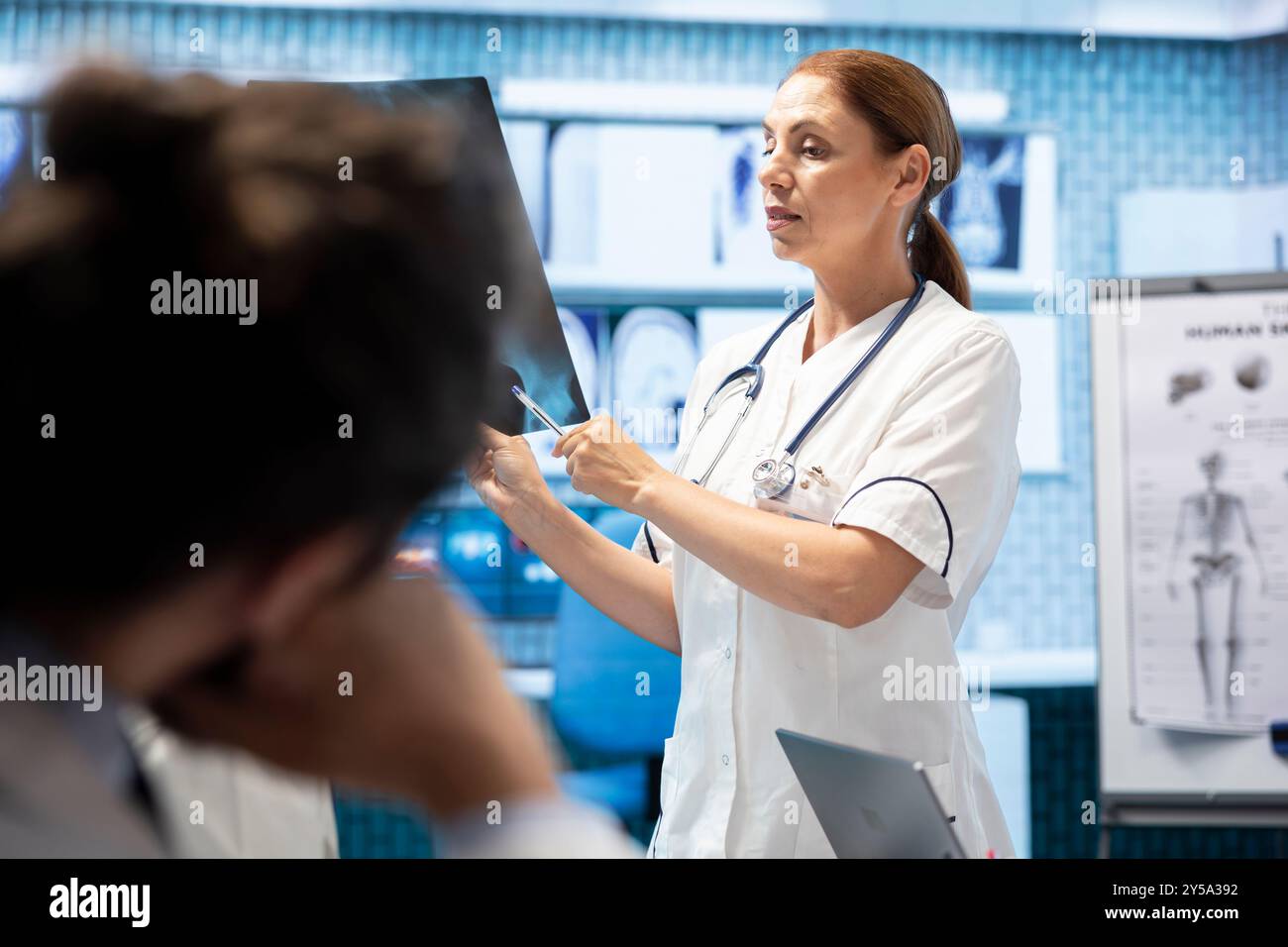 Medical experts meeting in a cabinet to discuss radiography test ...
