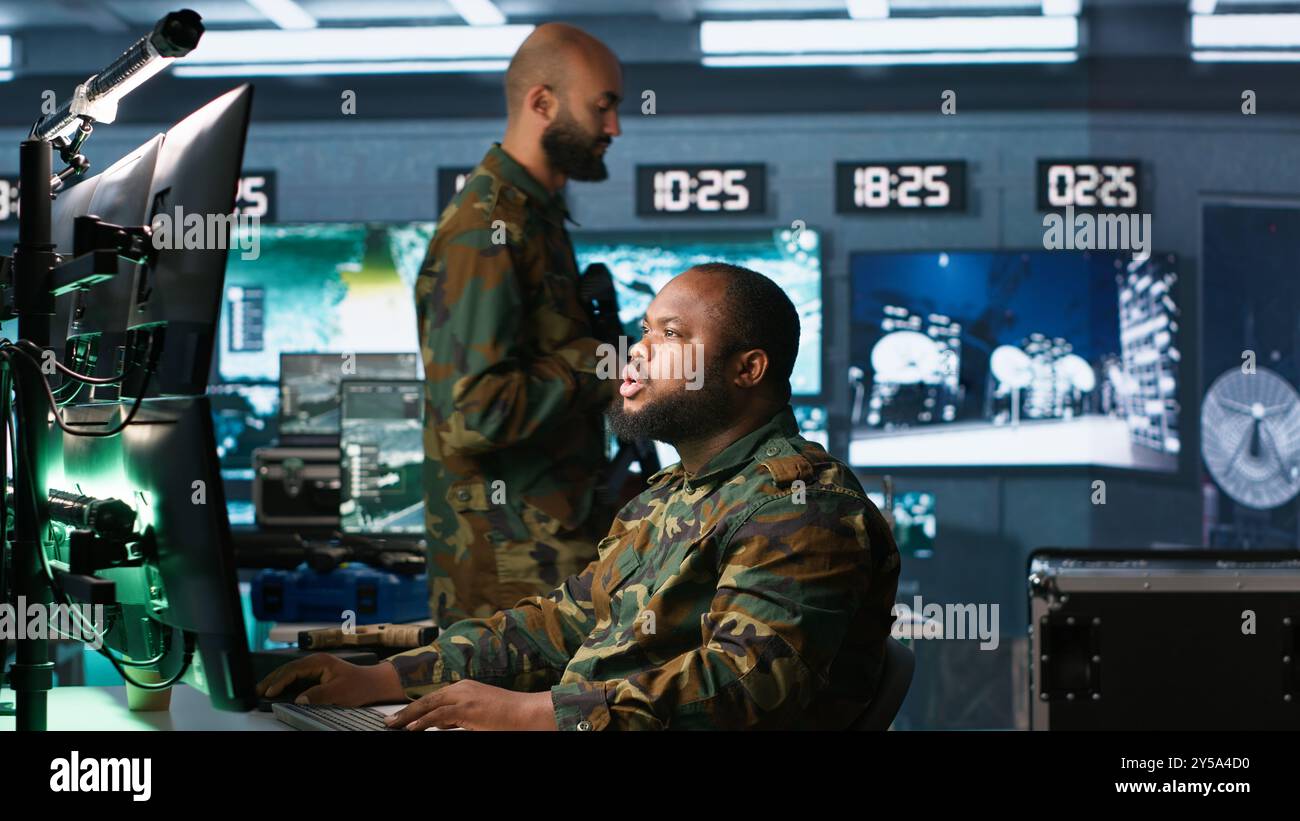 Military agent working in control room, analyzing aerial reconnaissance ...