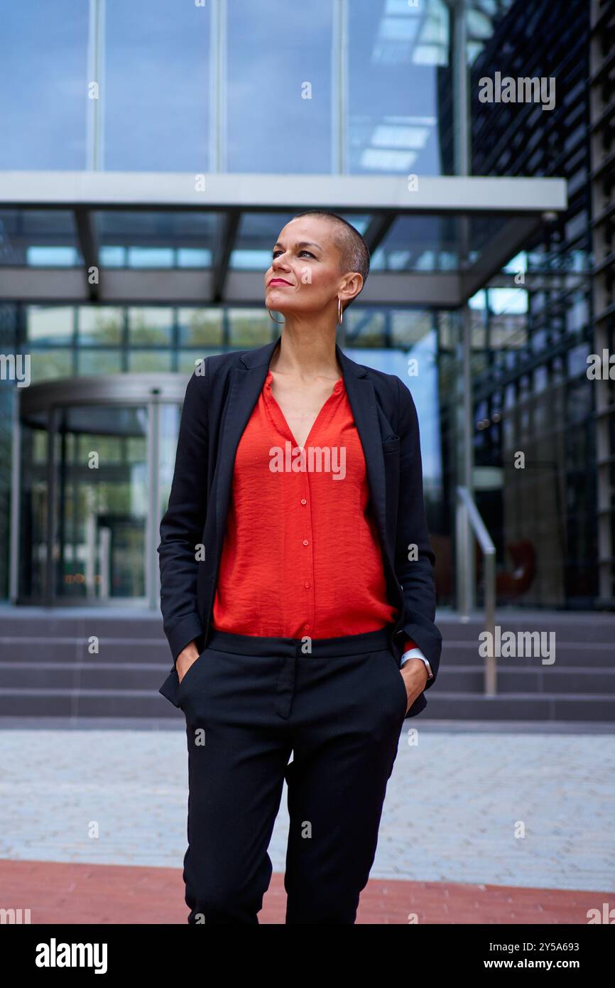 Empowered adult formal business woman posing standing looking upwards ...