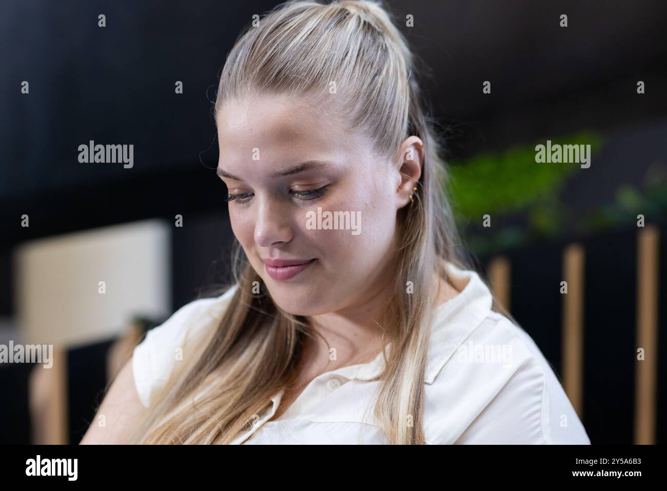 Thoughtful woman wearing white shirt hi-res stock photography and ...