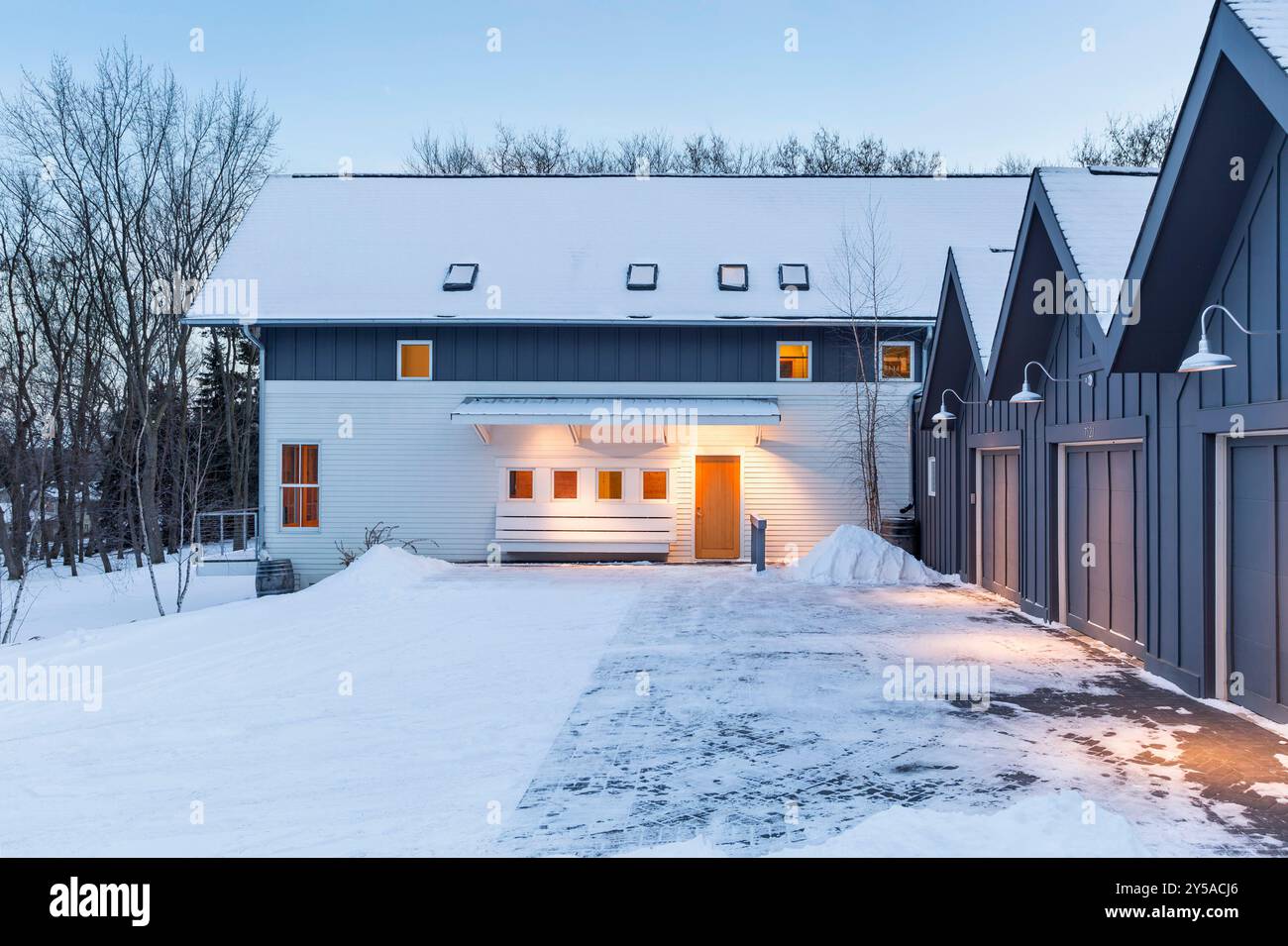 Side of modernist Nordic house showing showing courtyard and garages ...