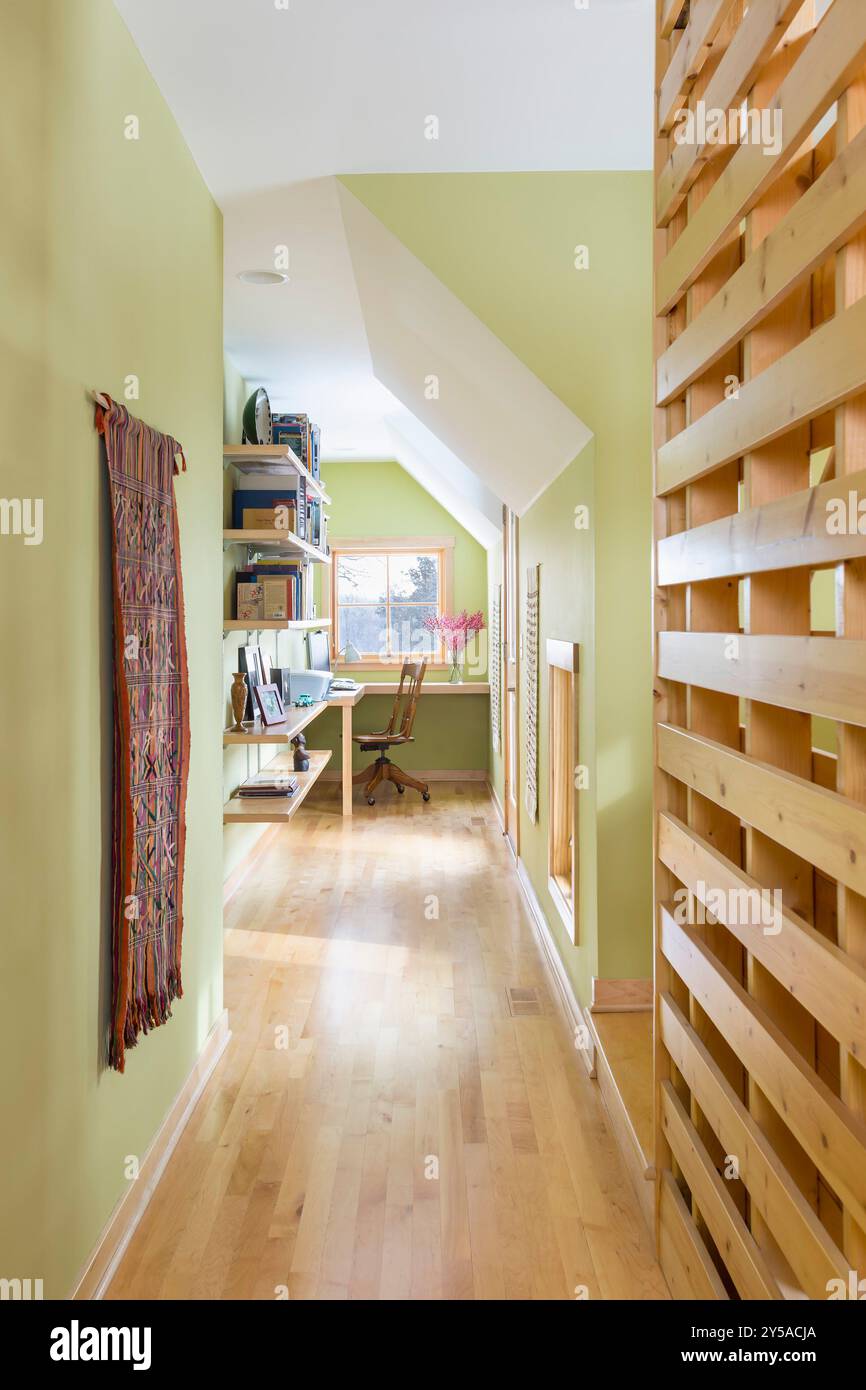Home office at end of long narrow hallway with lots of natural light ...