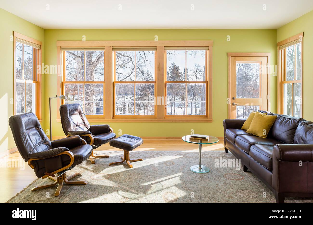 Bright sunny living room with view outside of trees and river Stock ...