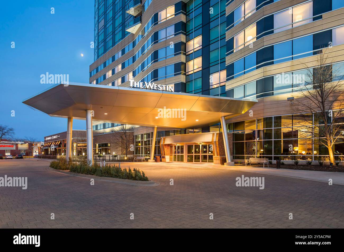 Front entrance of hotel showing canopy over door and brick driveway ...