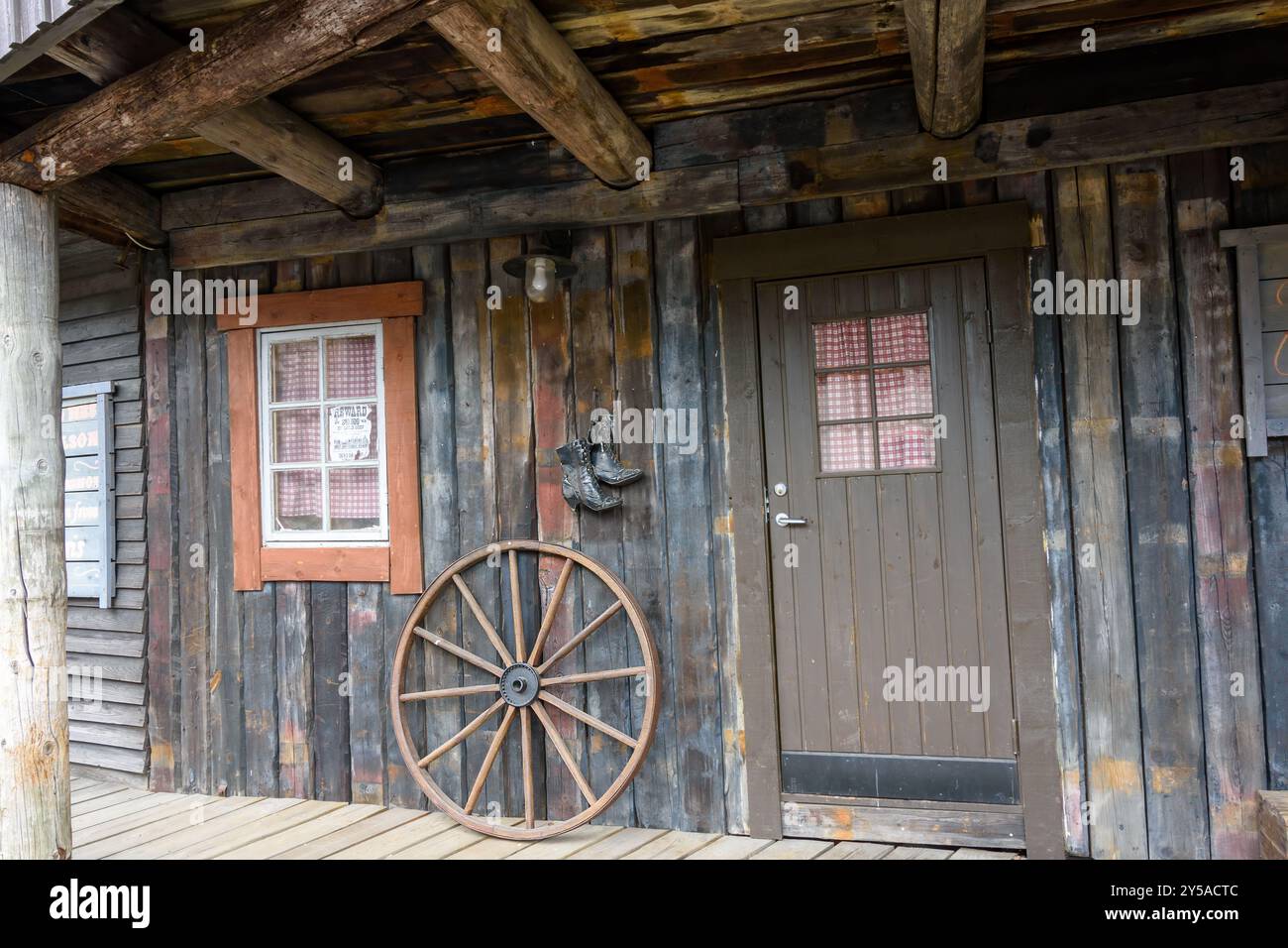 old west building with door, window and wagon wheel Stock Photo - Alamy