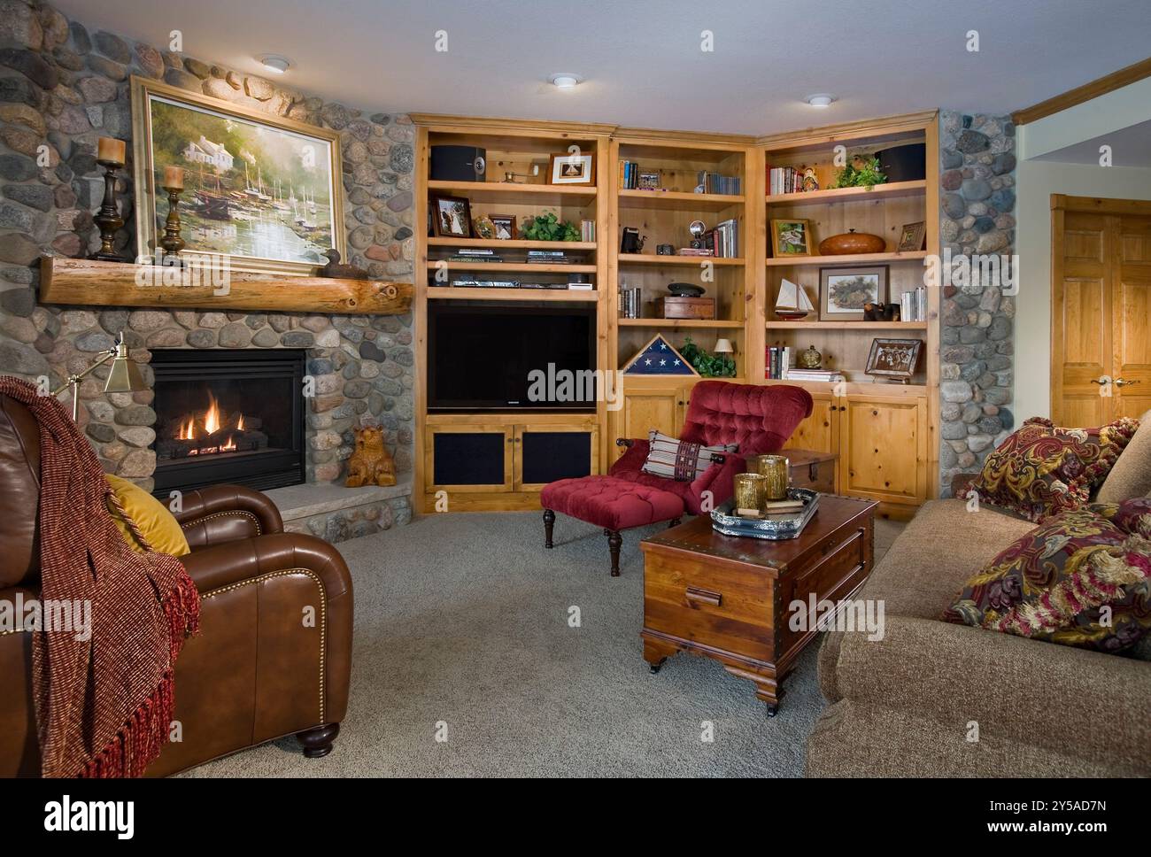 Cozy family room with field stone fireplace Stock Photo - Alamy