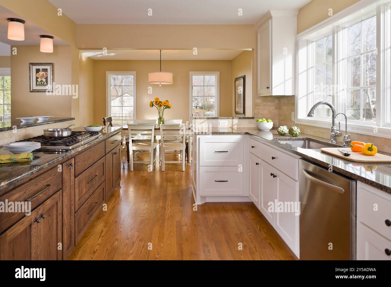 Sunny warm kitchen with view into dining room Stock Photo - Alamy