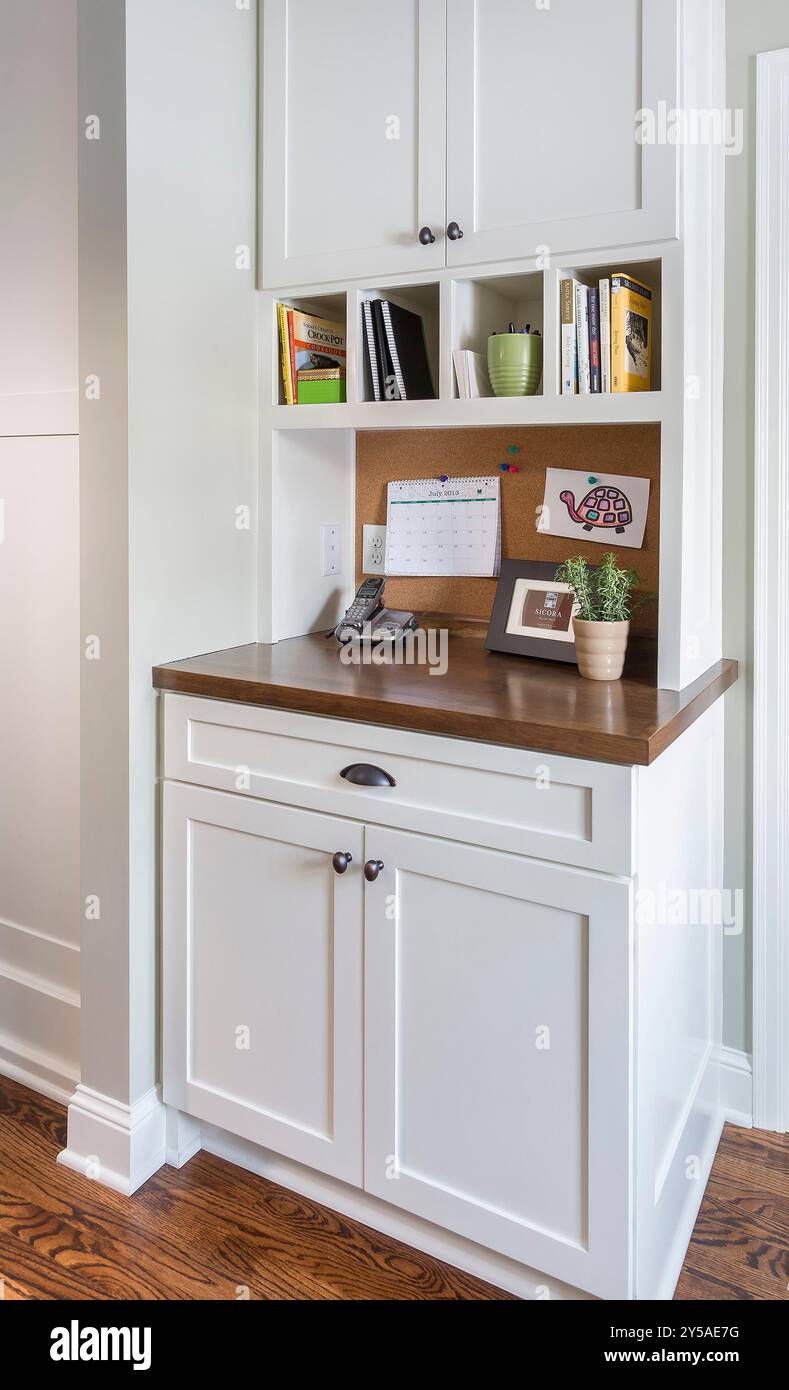 Built-in cabinet and counter that serves as small office area near ...