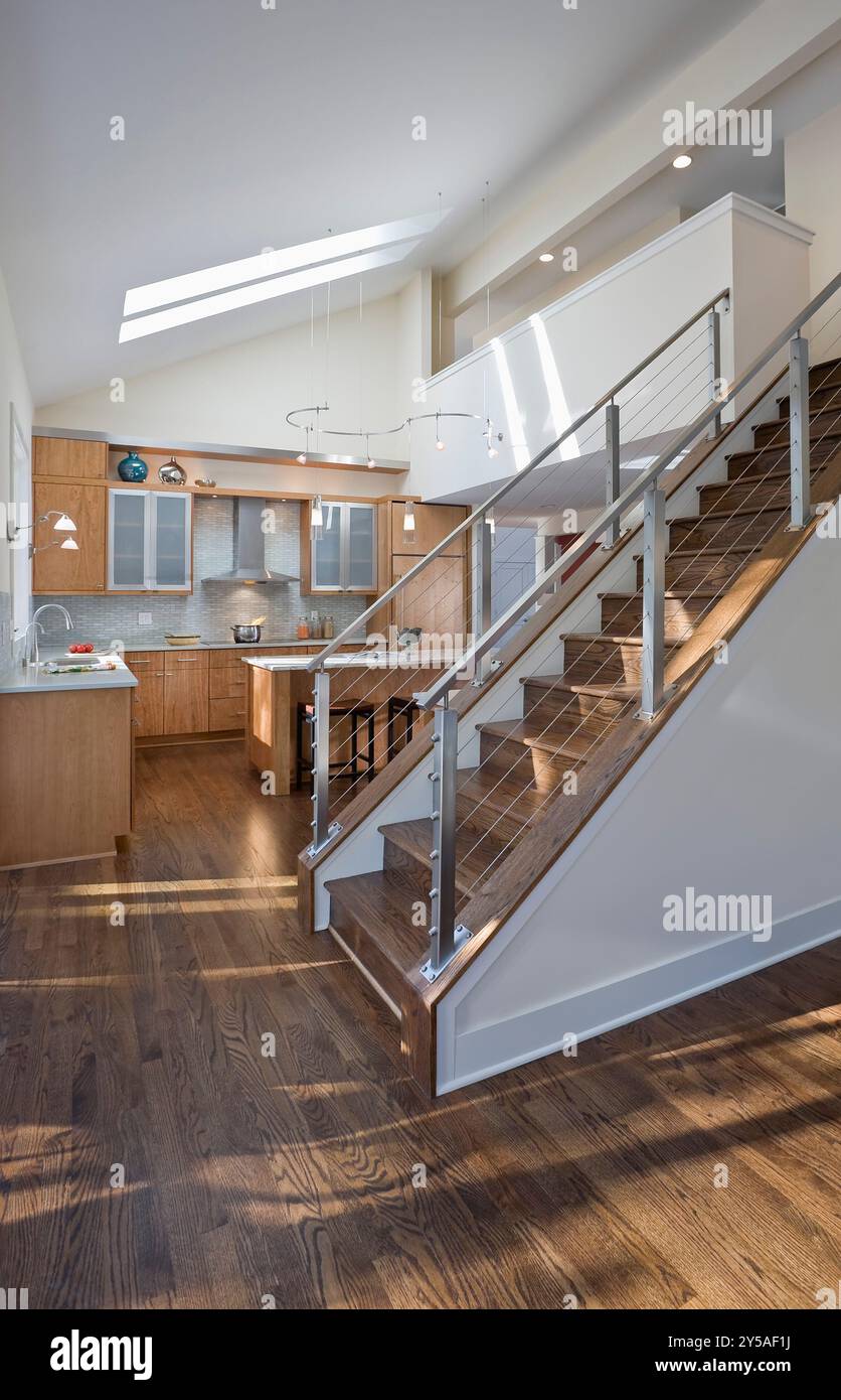 Open stairway comes down into kitchen in modern home Stock Photo - Alamy