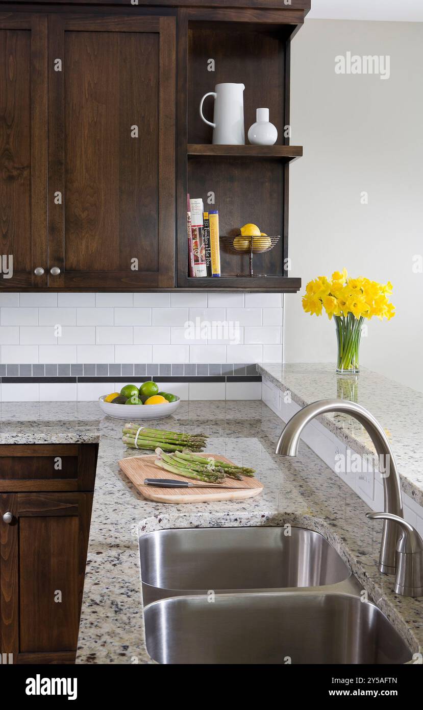 Corner of kitchen with dark wood cabinets, granite countertops and ...