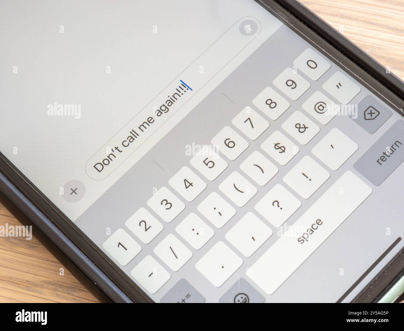 A close-up photo of a smartphone screen displaying a confrontational ...