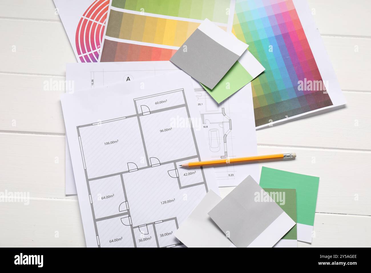 Designer's workplace with color palettes, floor plans and pencil on ...
