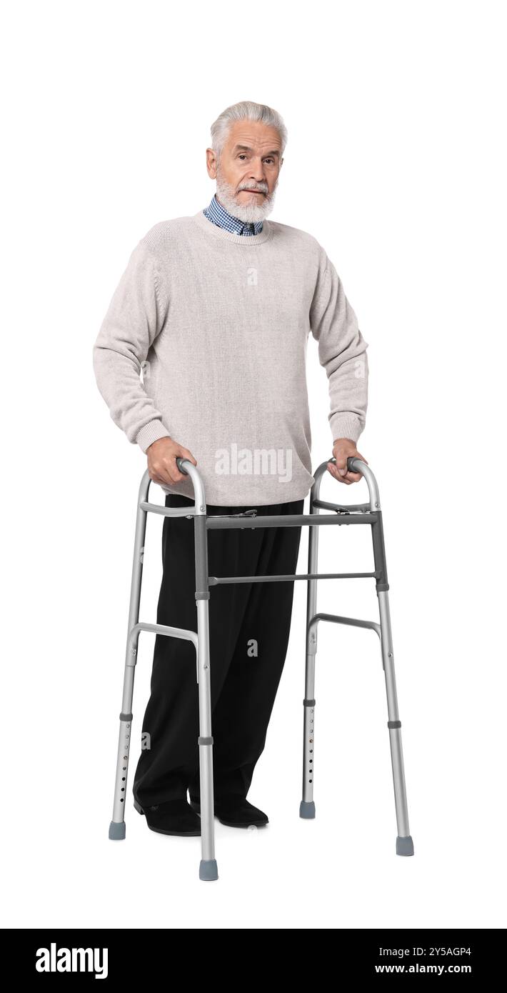 Senior man using walking frame on white background Stock Photo - Alamy