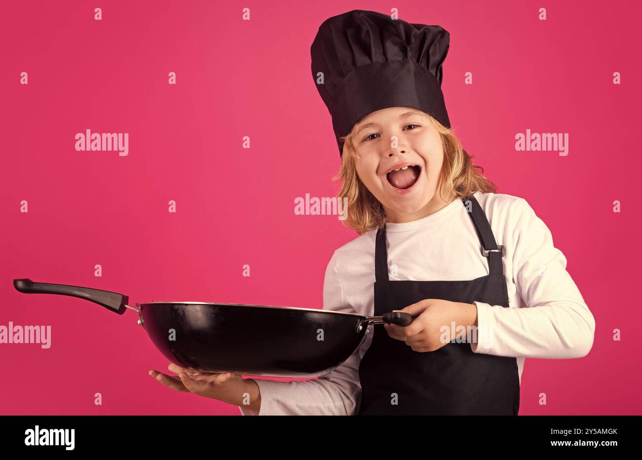 Child chef cook with pan. Child chef cook. Child wearing cooker uniform ...