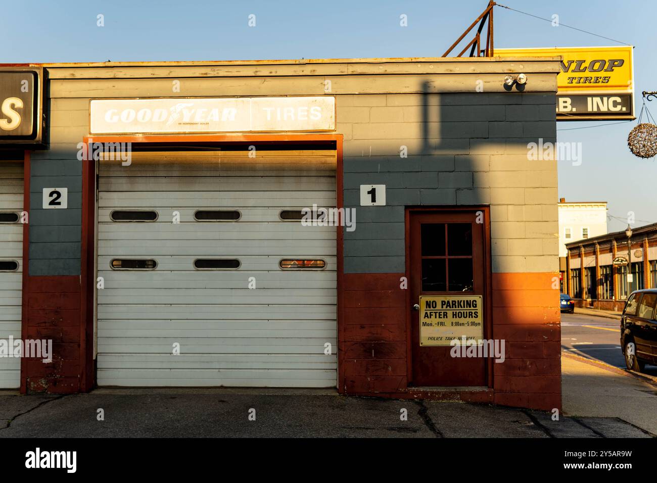 Car garage on a busy street. Shadows from the golden hour brighten up ...