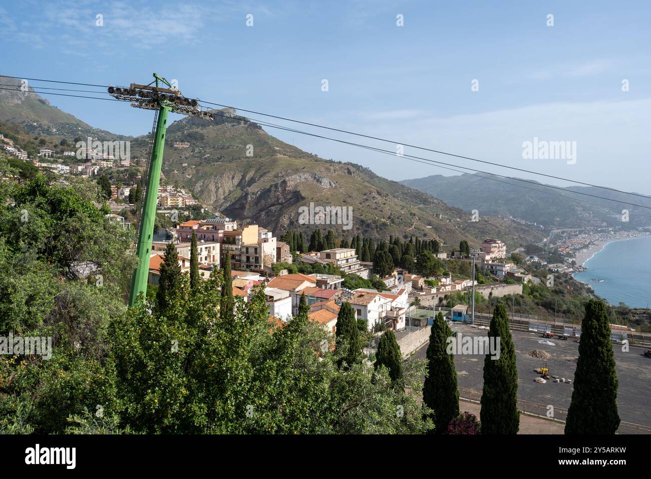 Taormina, Italy - June 19, 2024: Cityscape view. A cable car support ...