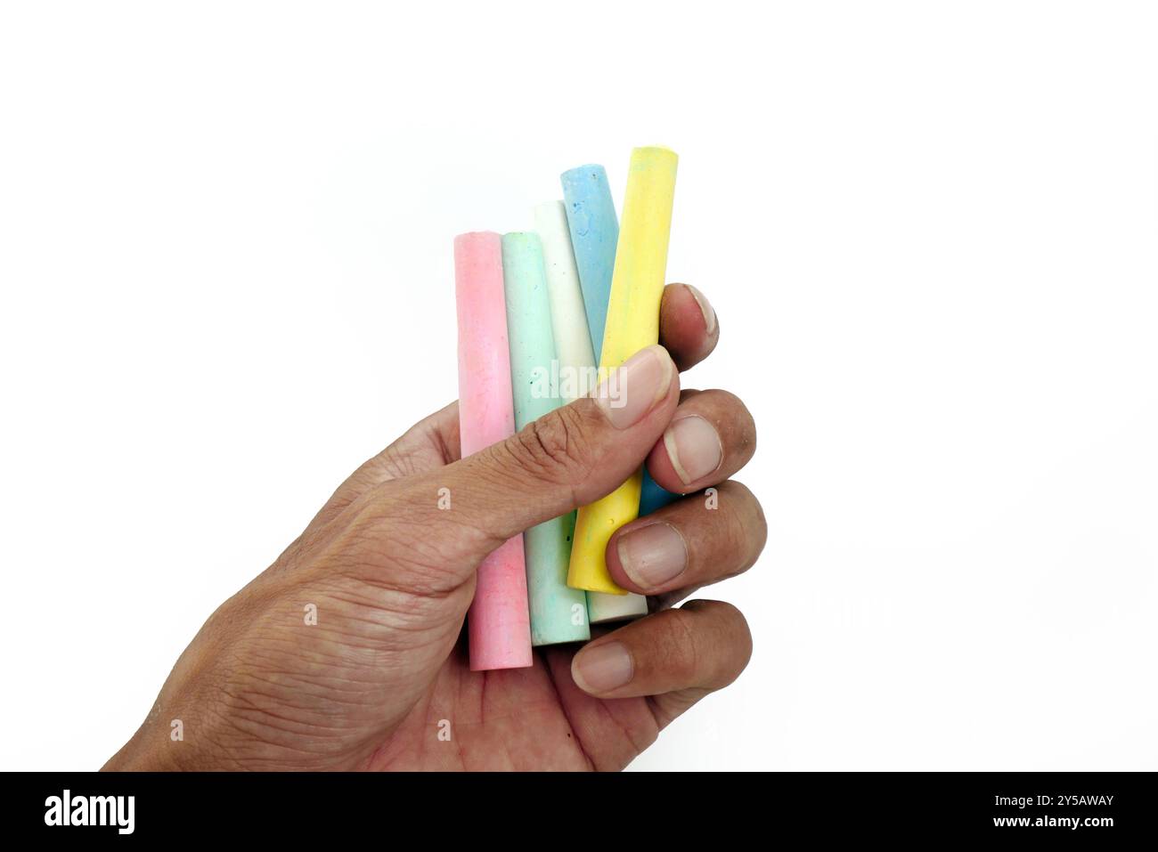 Teacher's hand holding colorful chalk isolated on white background ...